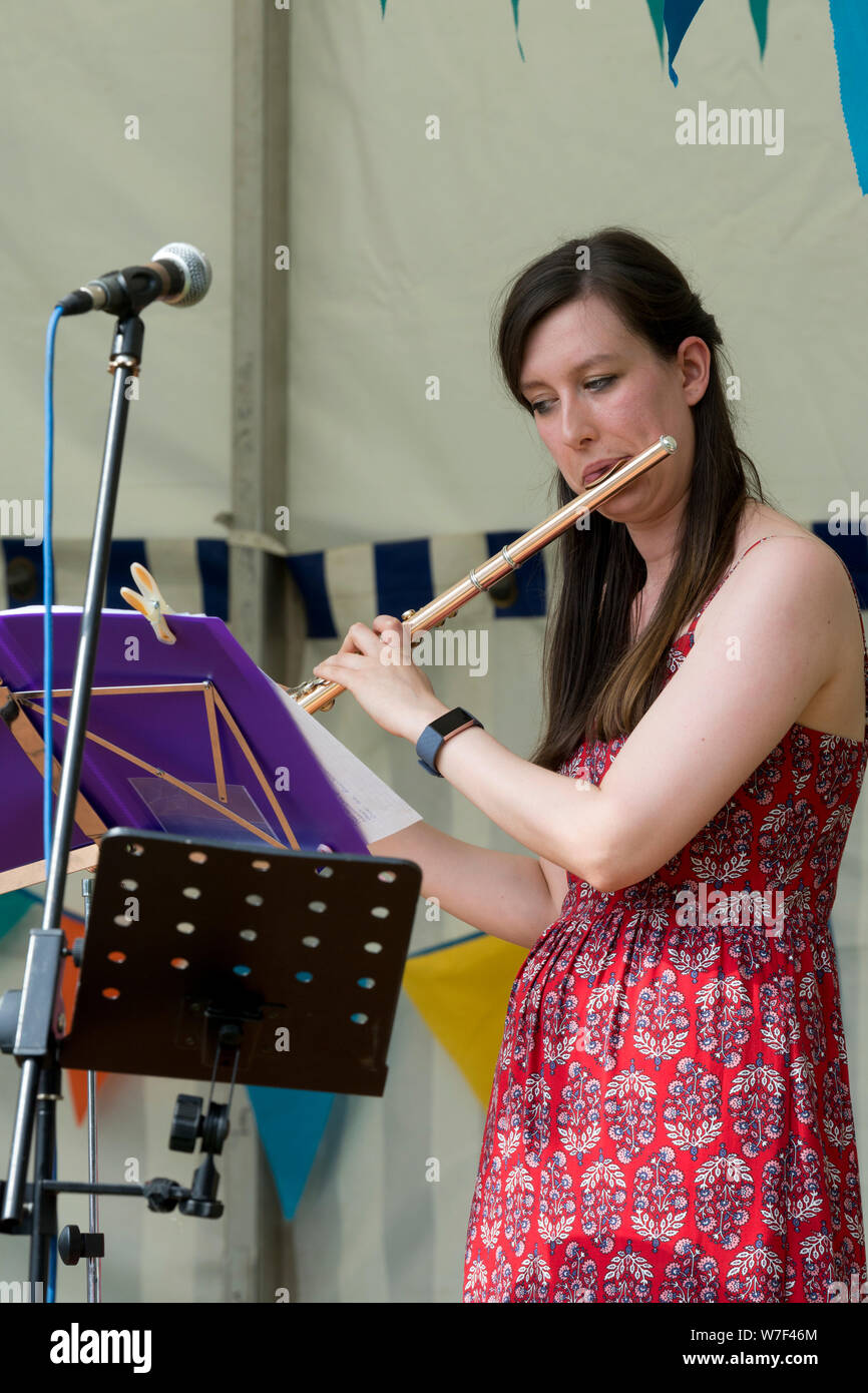 Young woman playing flute hi-res stock photography and images - Alamy