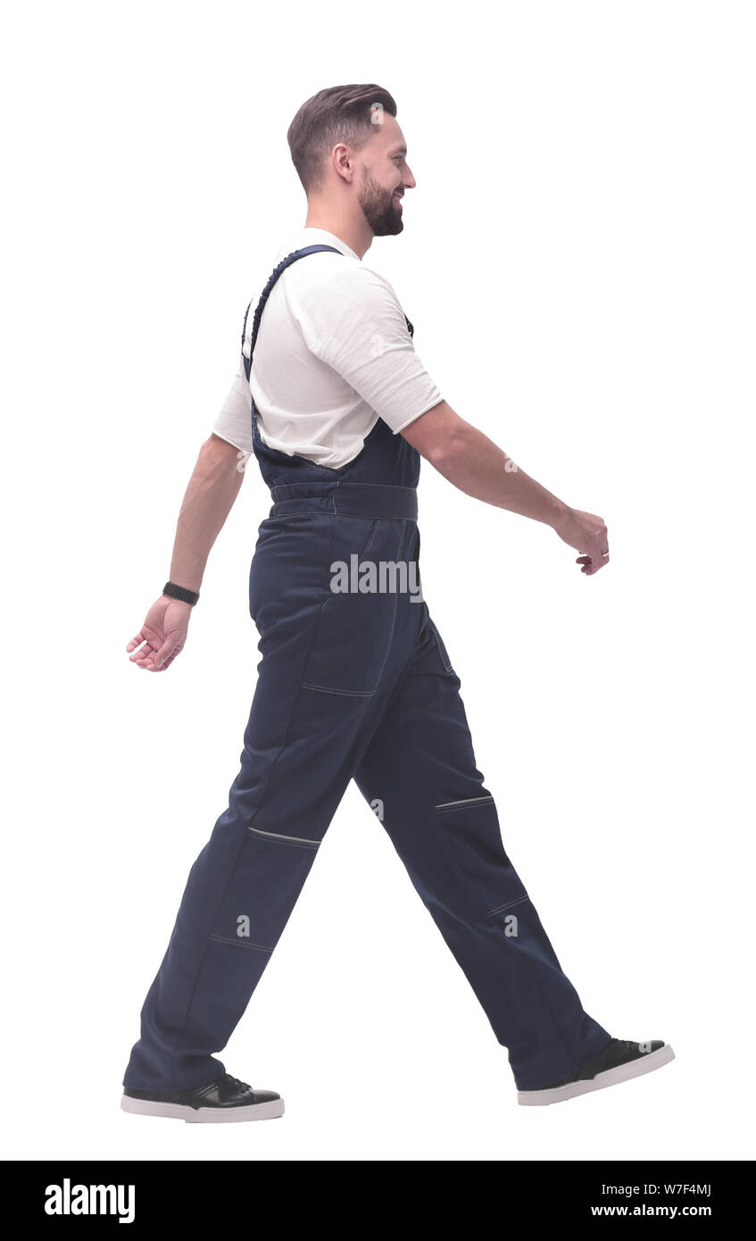 side view. smiling man in overalls confidently striding forward Stock ...