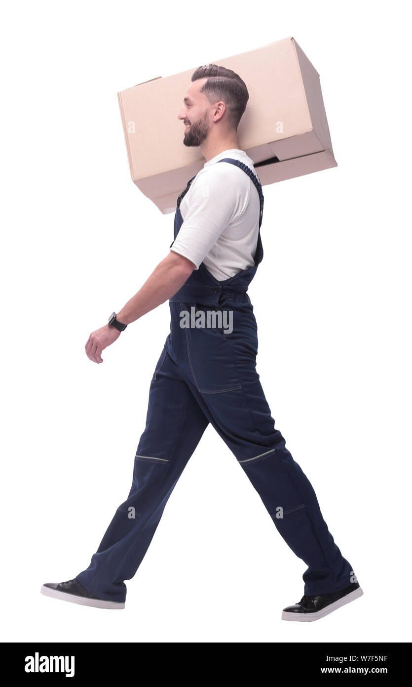side view. a man in overalls carries a large cardboard box Stock Photo ...