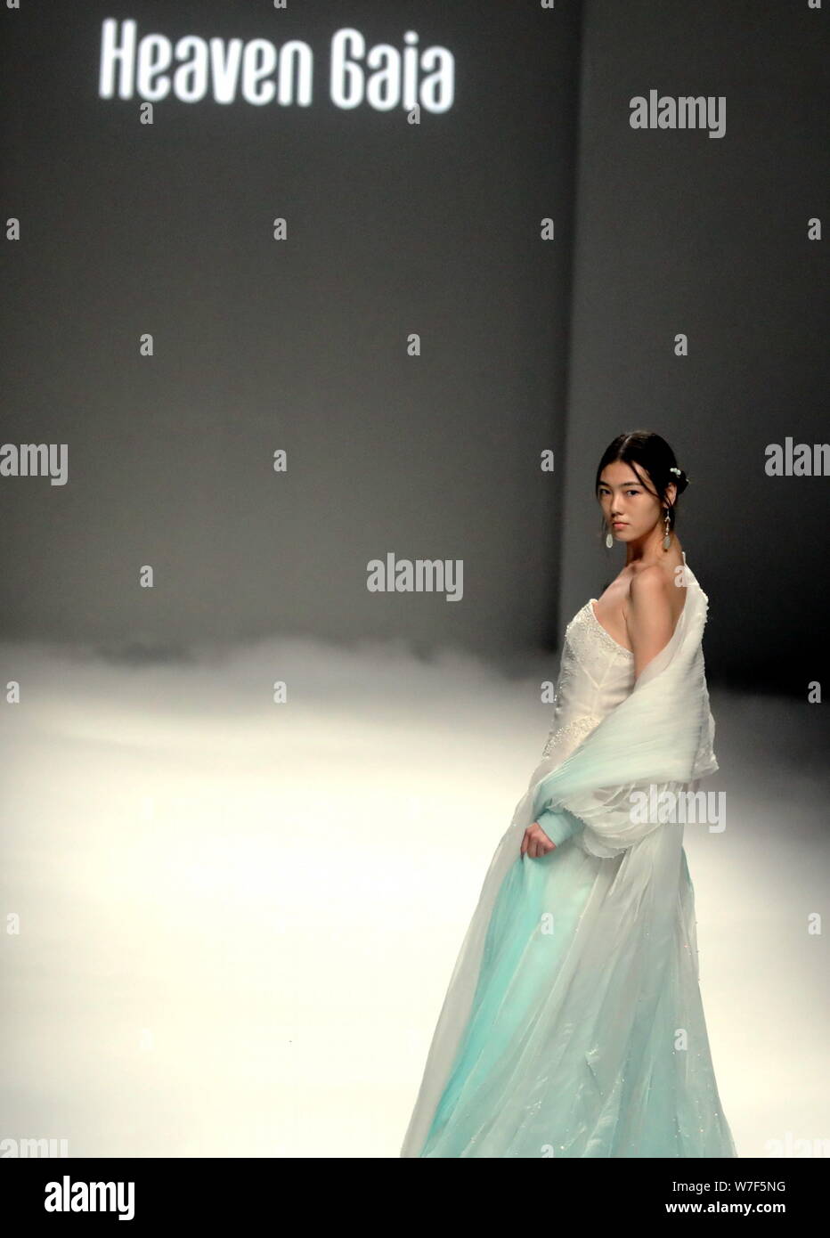 A model displays a new creation at the fashion show of Heaven Gaia ...