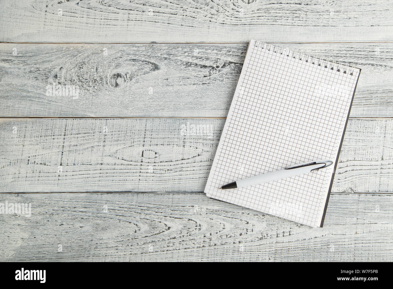 white paper Notepad and white pen on vintage shabby white wooden ...