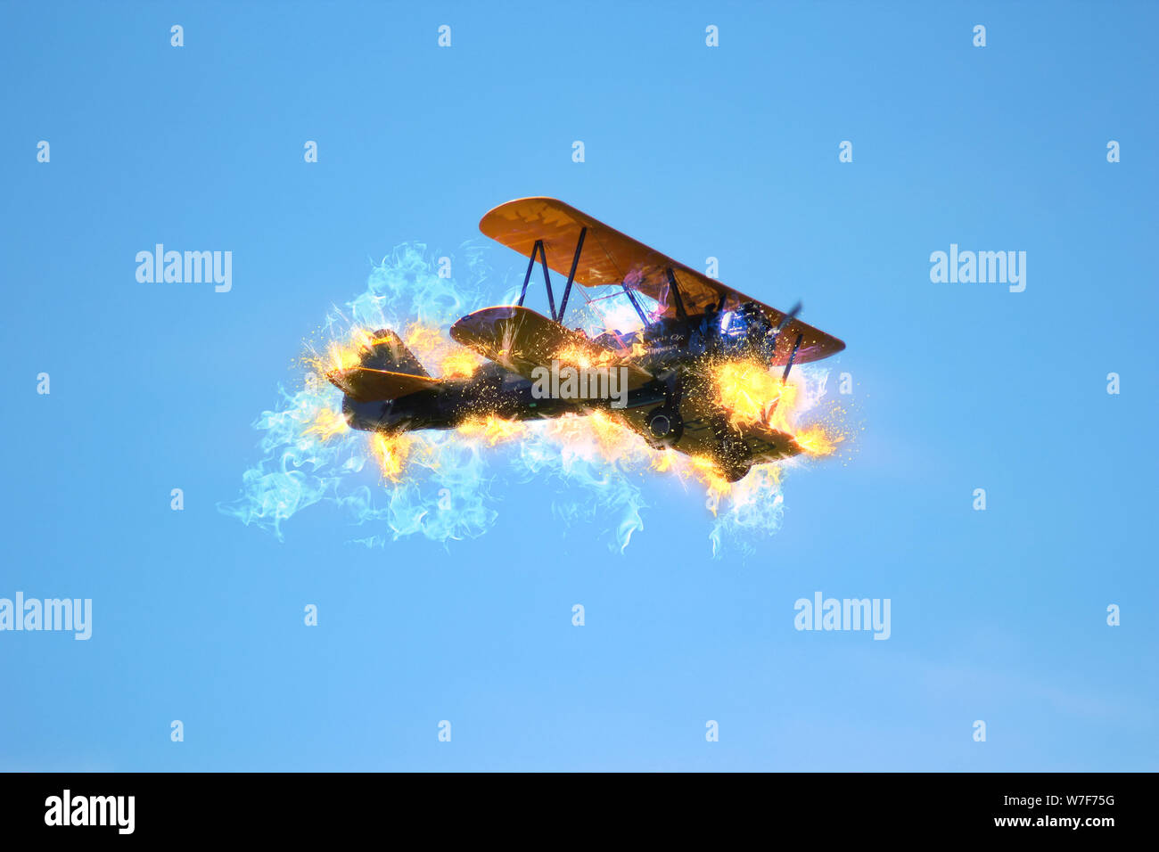 Digitally enhanced side view image of a burning biplane in flight Stock ...