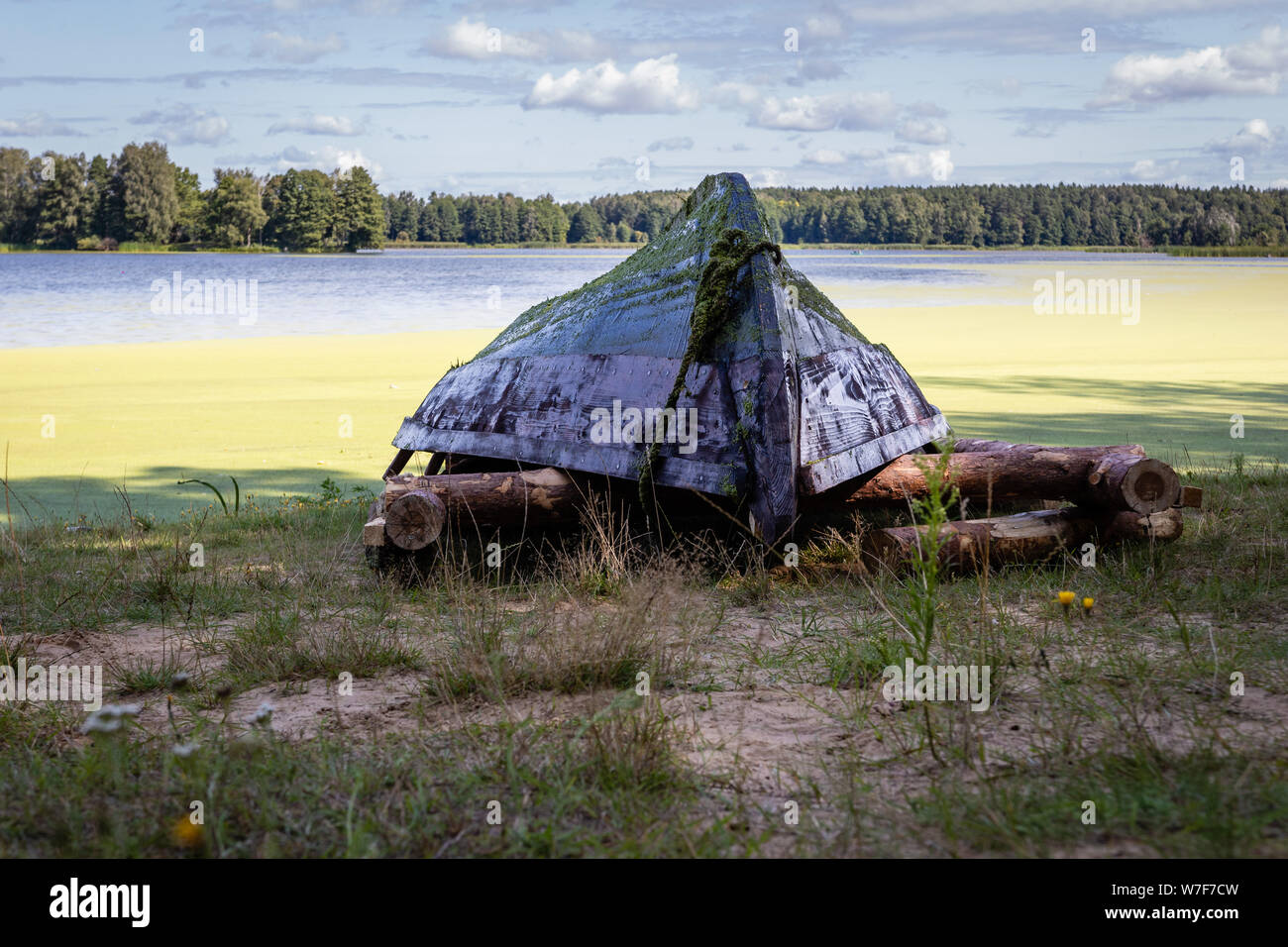 An inverted boat lies on the shore. Small drakkar made by old ...