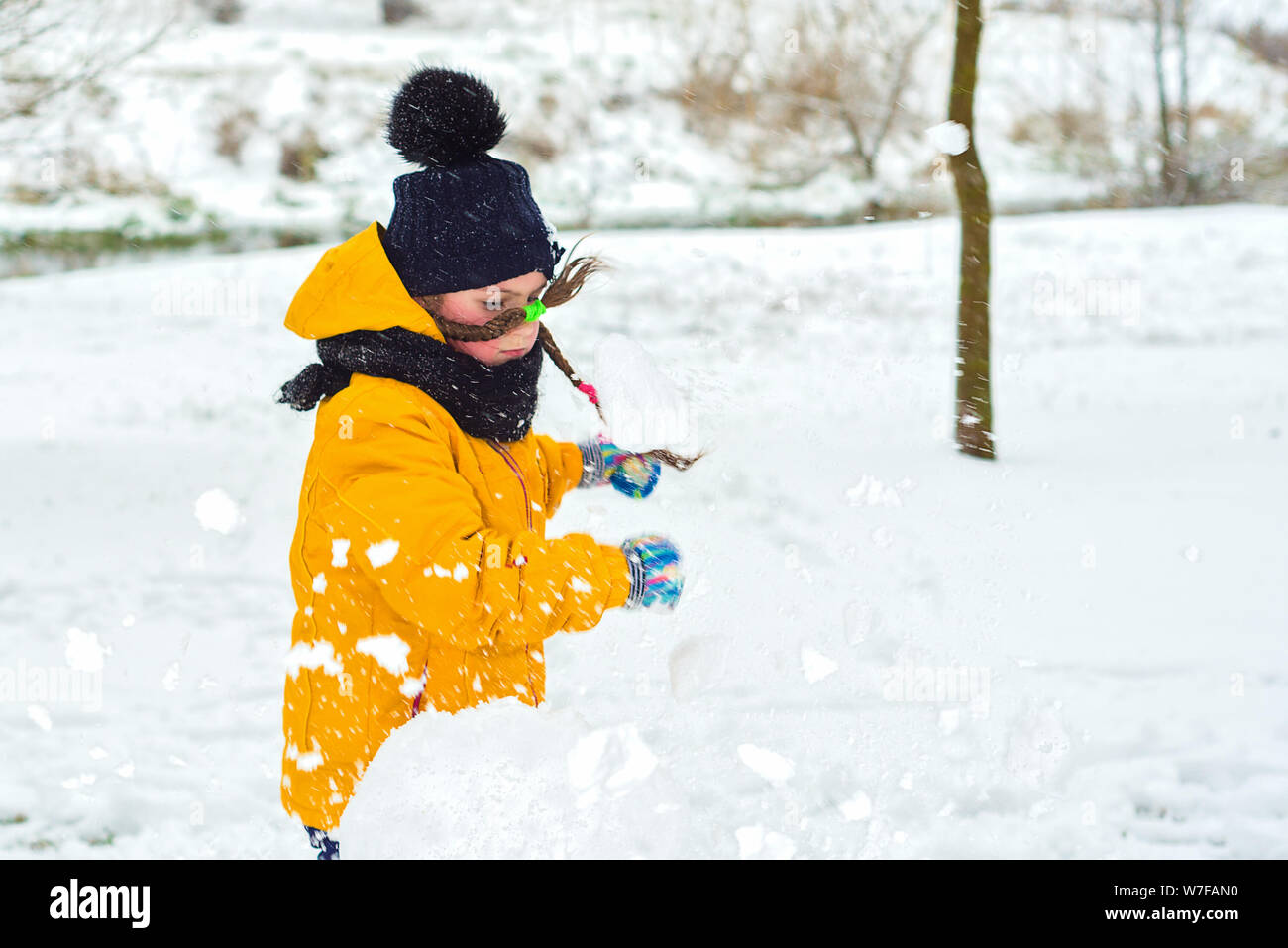 angry little girl in rage broke snowman Stock Photo - Alamy