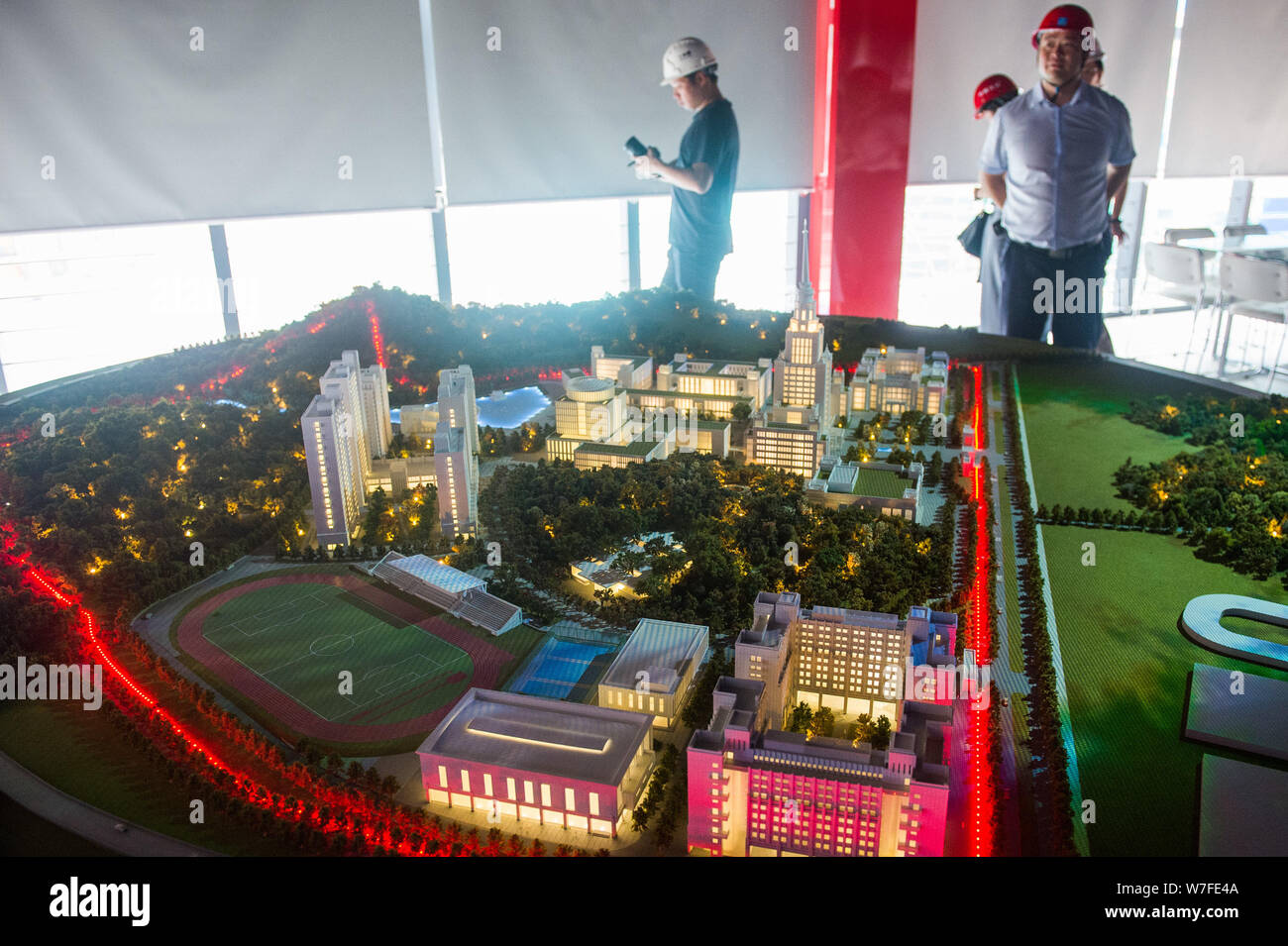 Visitors take photos of the model of Shenzhen MSU-BIT University, the ...