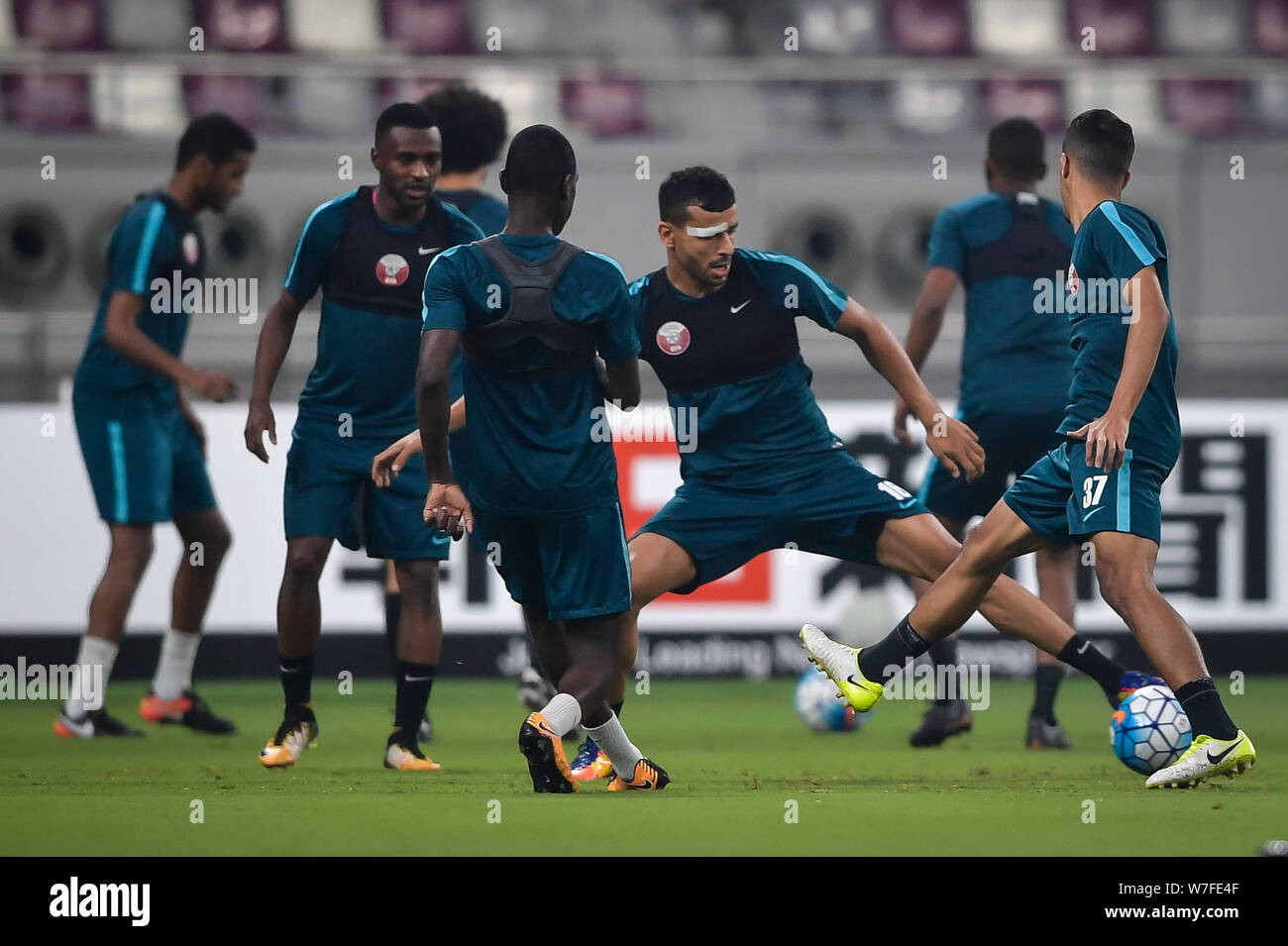 Players of the Qatar national football team take part in a training ...