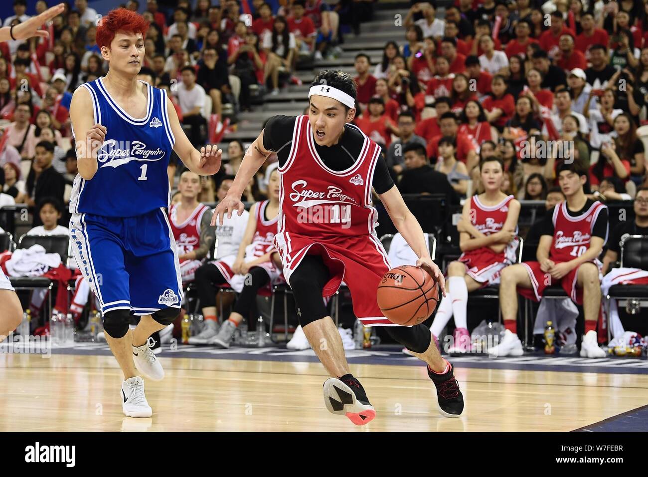 Chinese singer and actor Kris Wu or Wu Yifan, right, dribbles in the ...