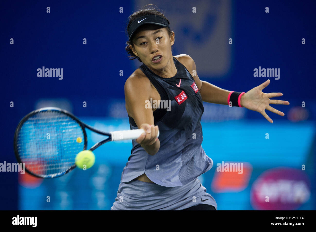 Zhang Shuai of China returns a shot to Donna Vekic of Croatia in their ...