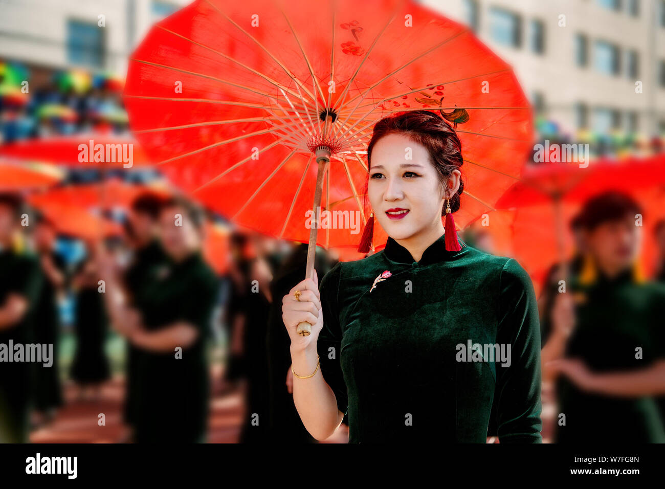Women display cheongsam, also known as qipao in Chinese, during an ...