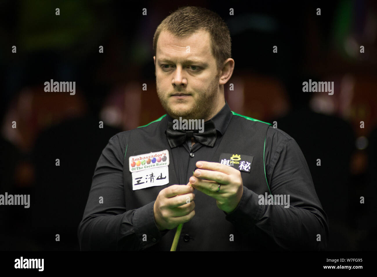 Mark Allen of Northern Ireland chalks his cue as he considers a shot to ...
