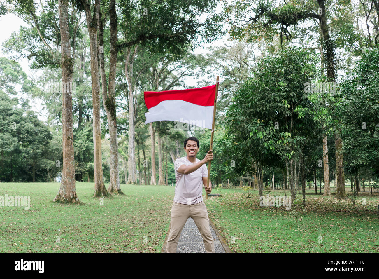 asian young man flapping Indonesian flag Stock Photo - Alamy