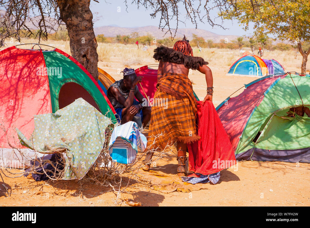 Herero women at a funeral gathering, tents and huts can be seen in the ...