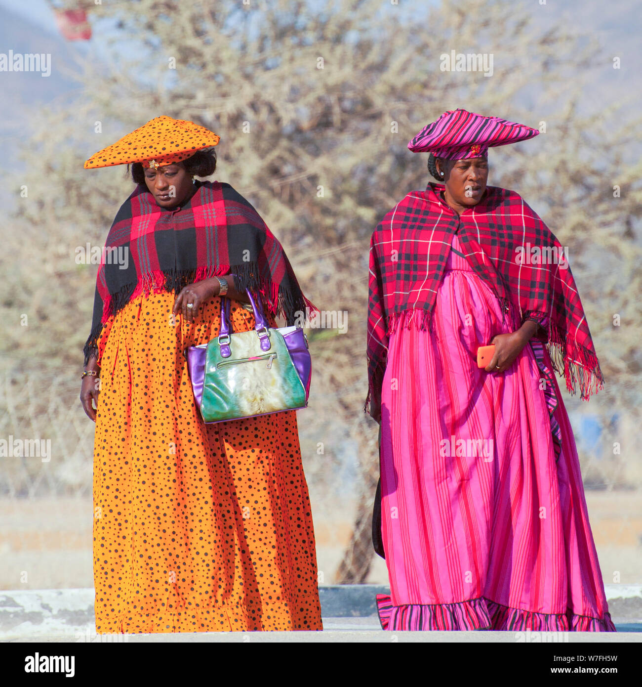 Herero women at a funeral gathering, tents and huts can be seen in the ...