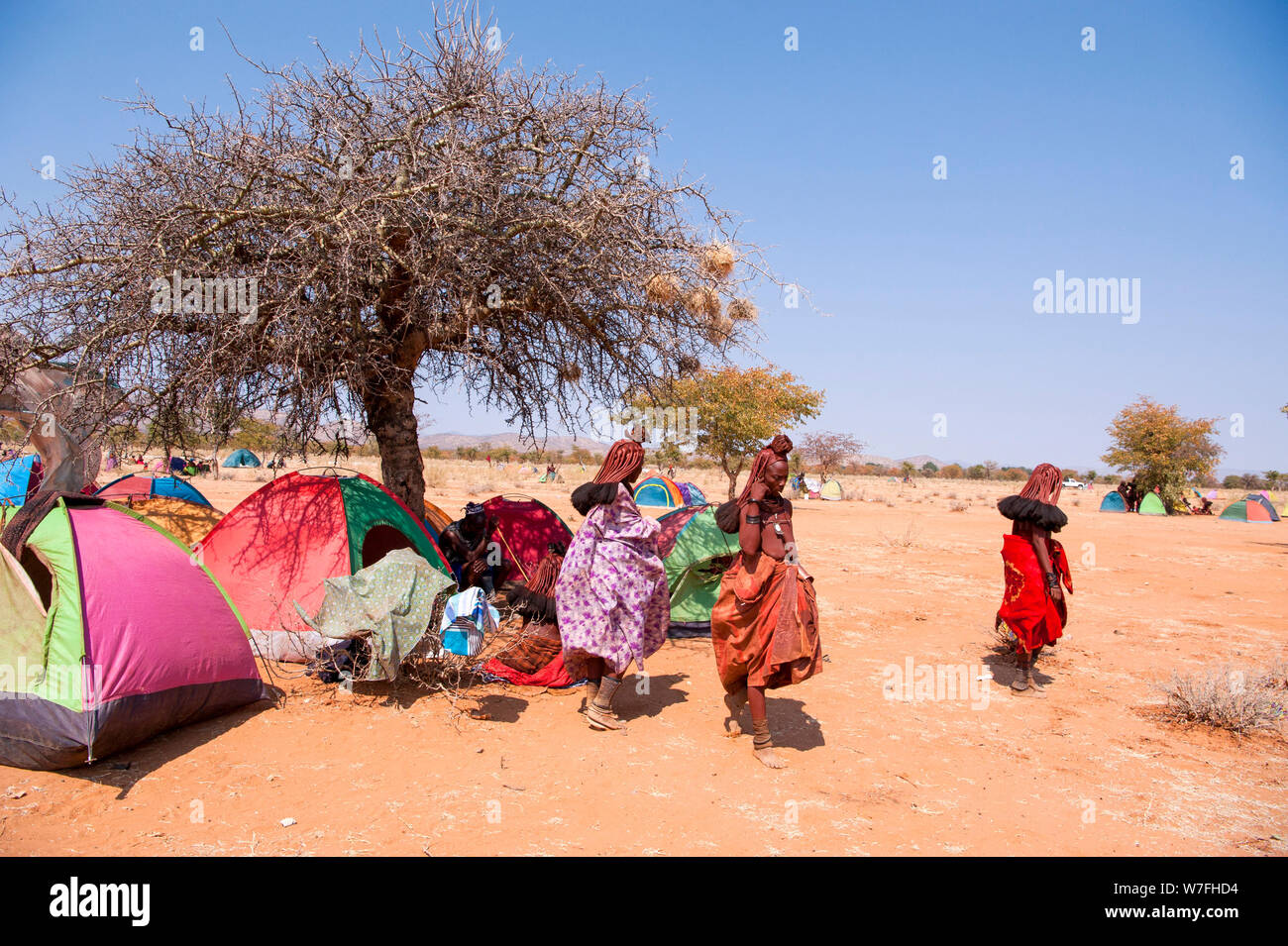 Herero women at a funeral gathering, tents and huts can be seen in the ...
