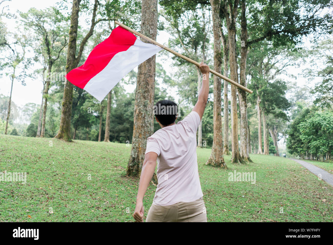 asian young man flapping Indonesian flag Stock Photo - Alamy