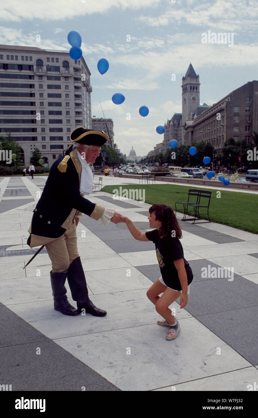 Actor dressed as George Washington posing with a young lady on ...