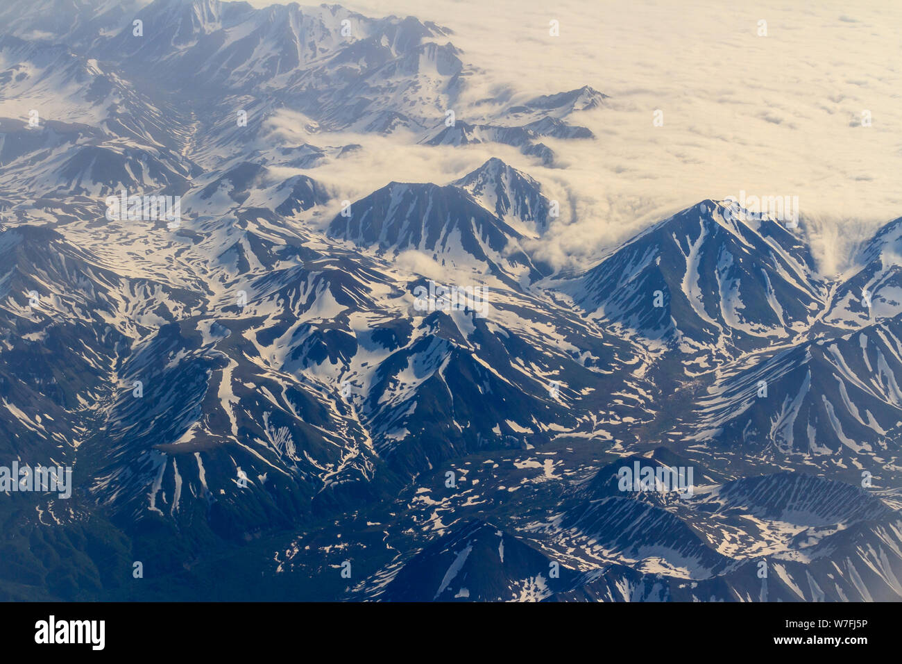 View of the Kamchatka mountains from the airplane porthole. Mount from ...