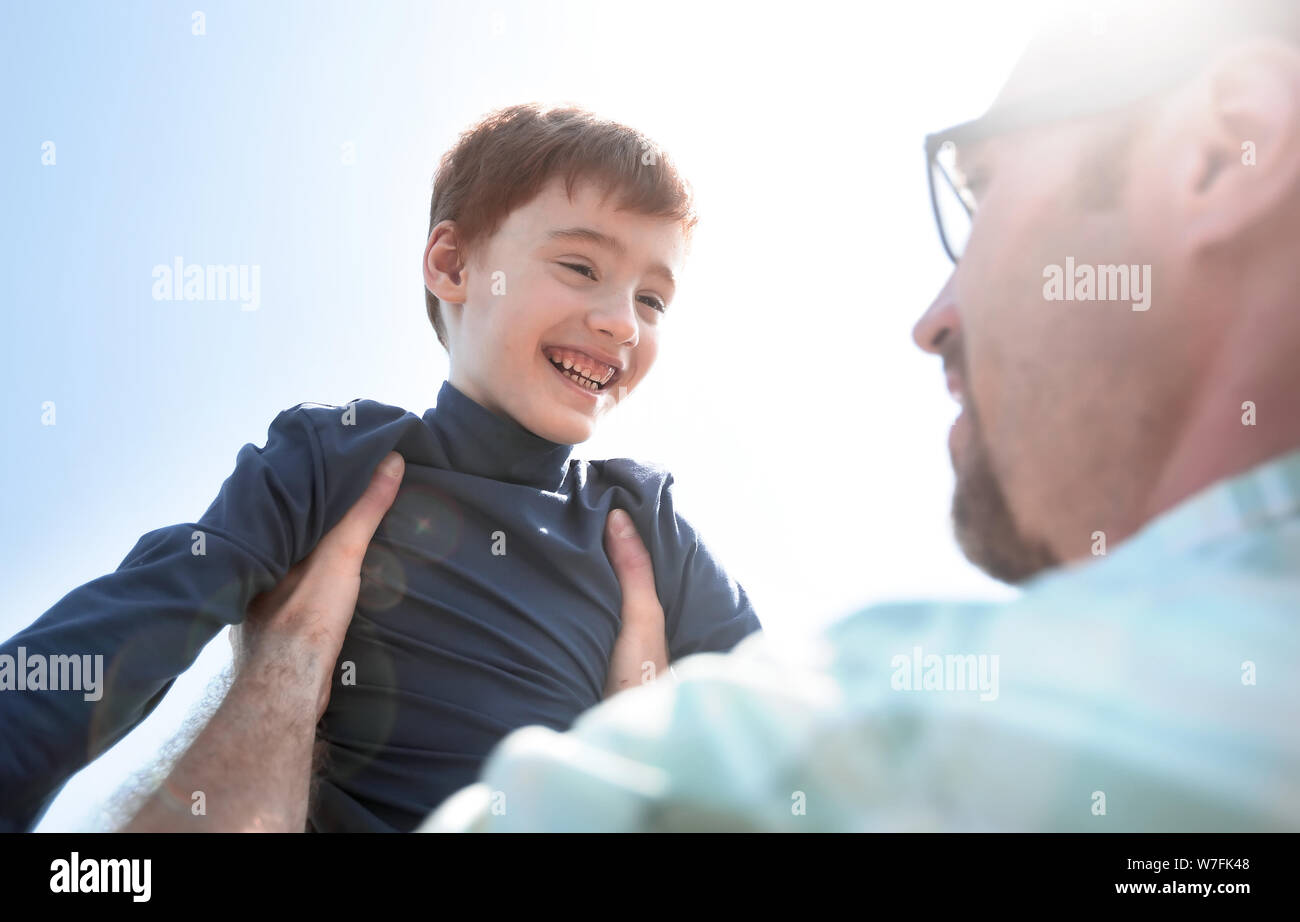 stylized photo.a happy son in his father's safe hands Stock Photo - Alamy