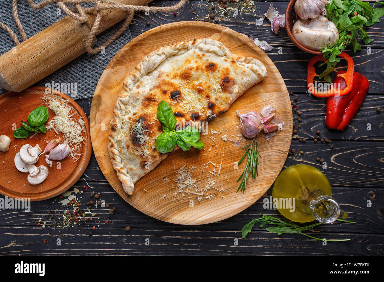 The appetizing meat pizza Calzone is folded in half Stock Photo - Alamy