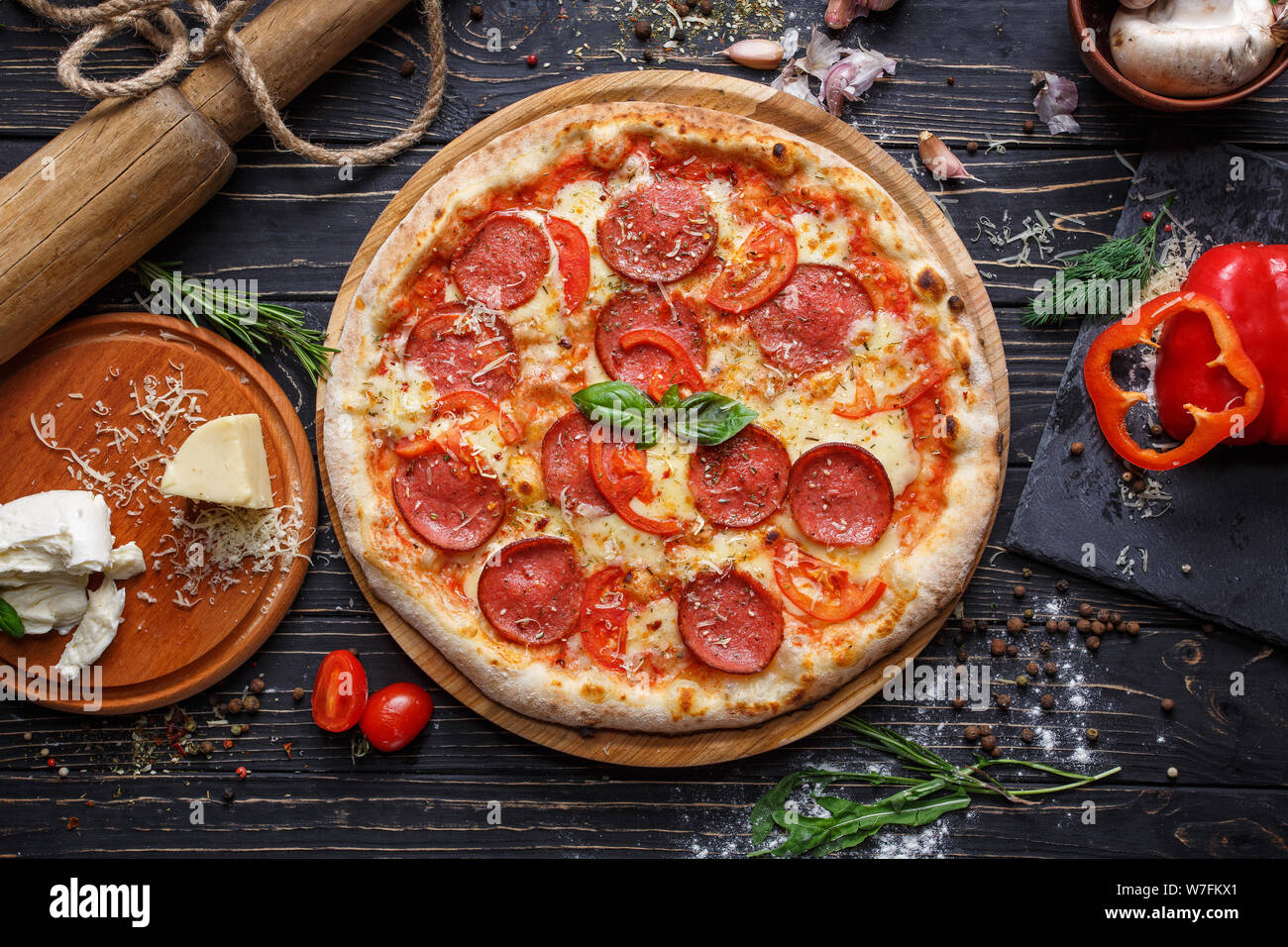 Hot pizza with sausage, Bulgarian pepper and spices Stock Photo - Alamy
