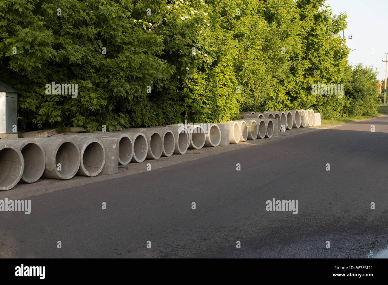 Close up stack of concrete drainage pipes for wells and water ...