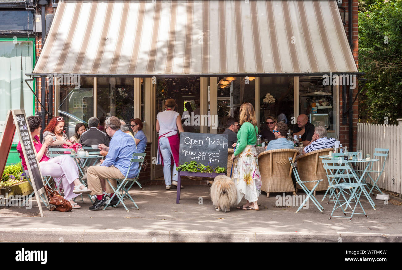 People seated eating and drinking outside a cafe, England, GB, UK Stock ...
