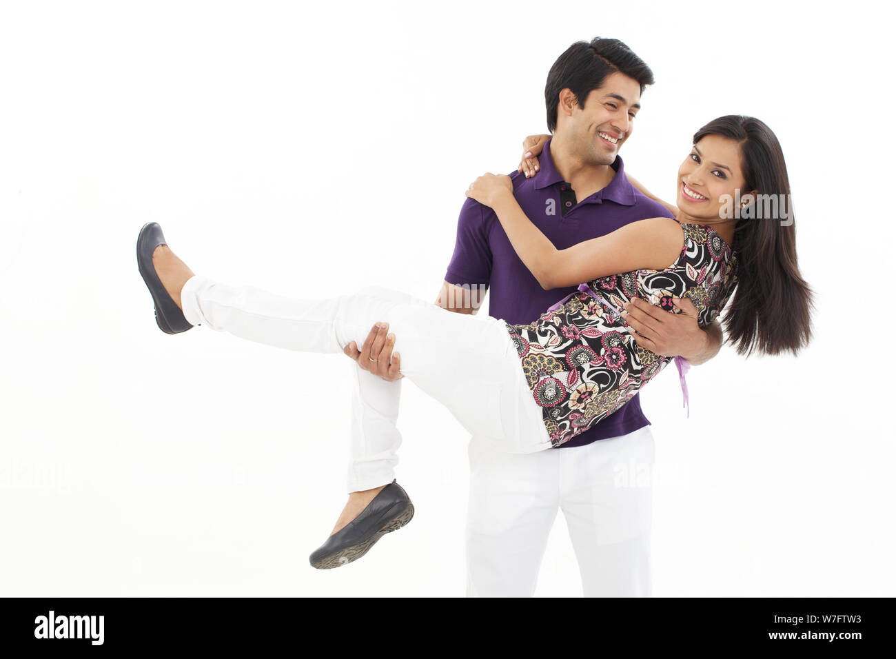 Young man carrying his girlfriend isolated on white background Stock ...