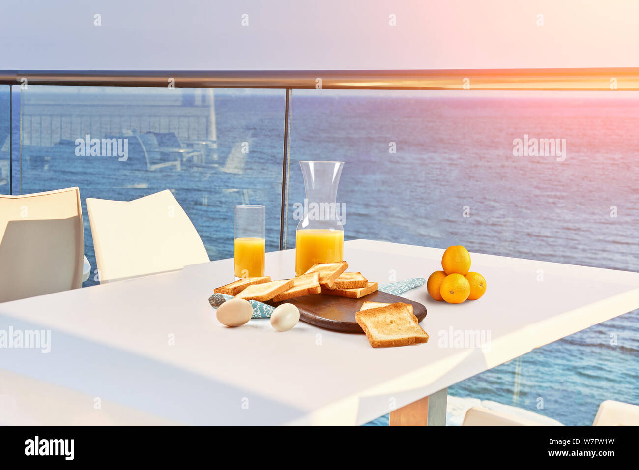 Table for two served with a breakfast on outdoor hotel balcony with a ...