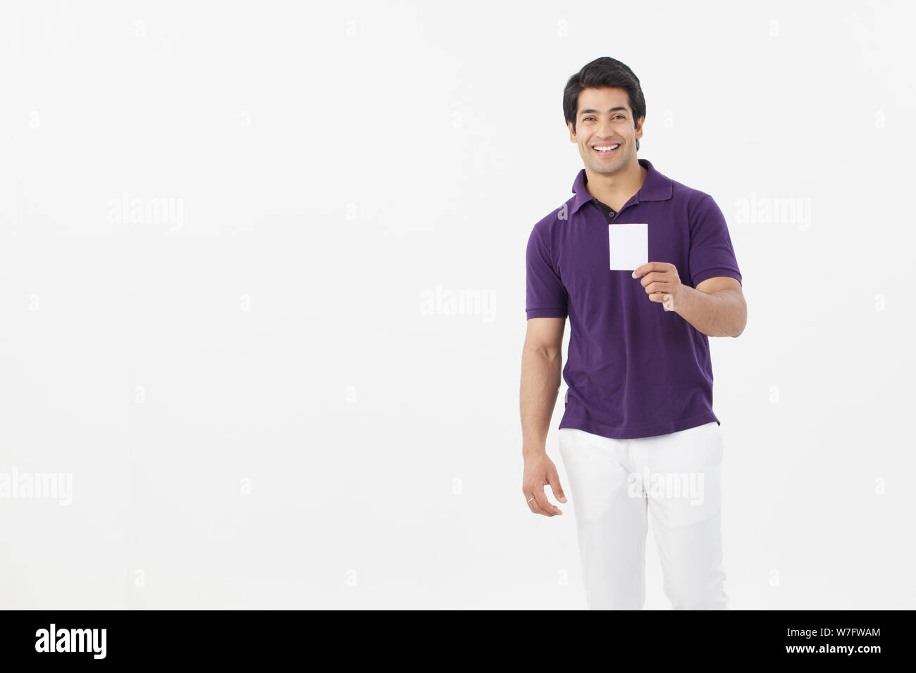 Young man looking at photograph Stock Photo - Alamy
