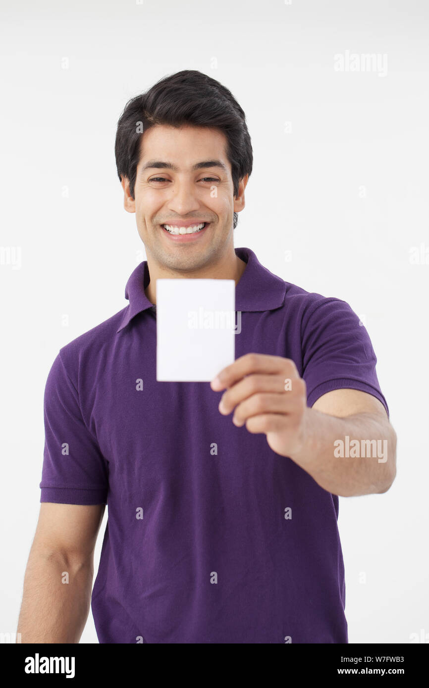 Young man looking at photograph Stock Photo - Alamy
