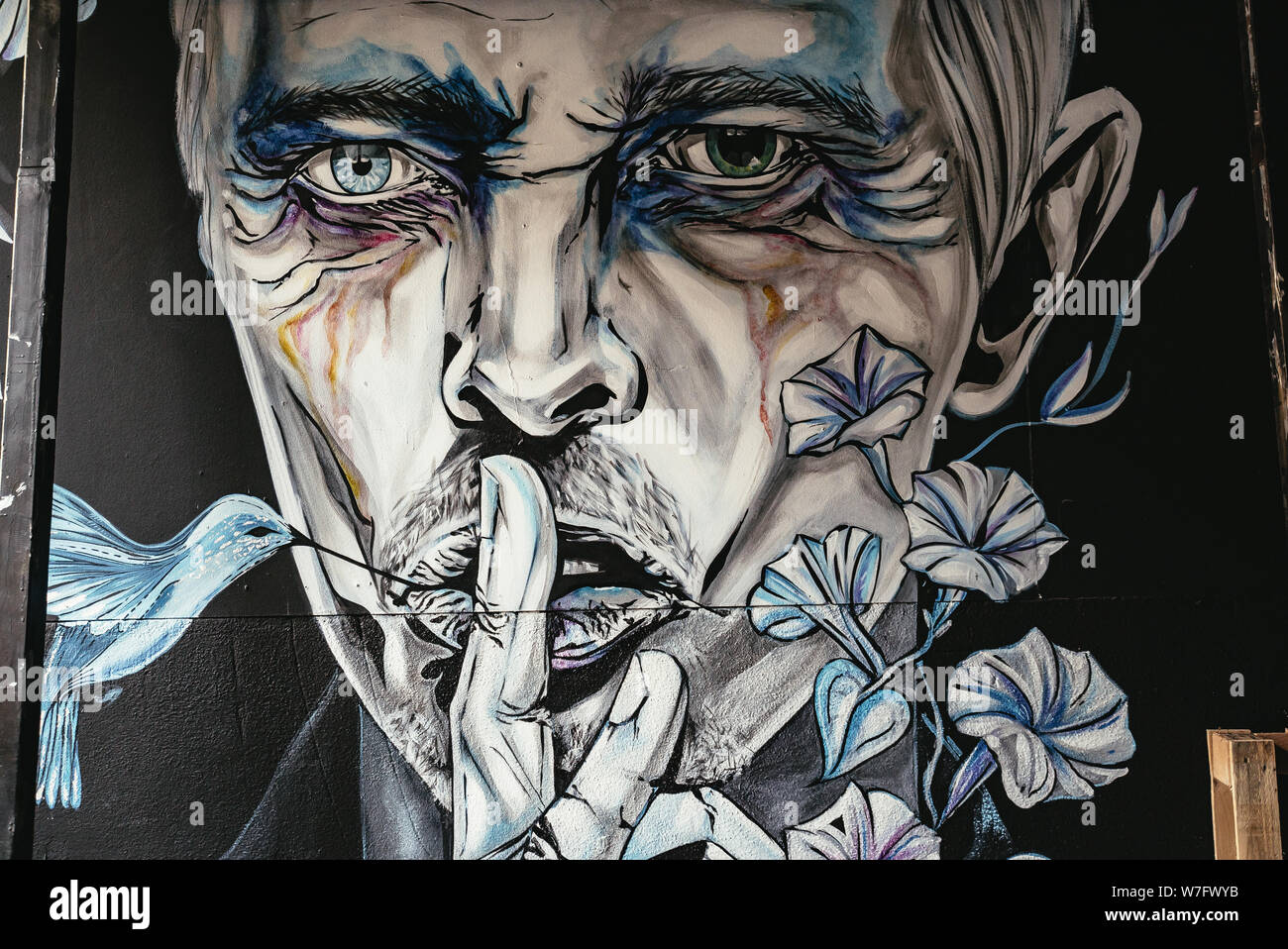 Wall mural of a man making a shush gesture Stock Photo - Alamy