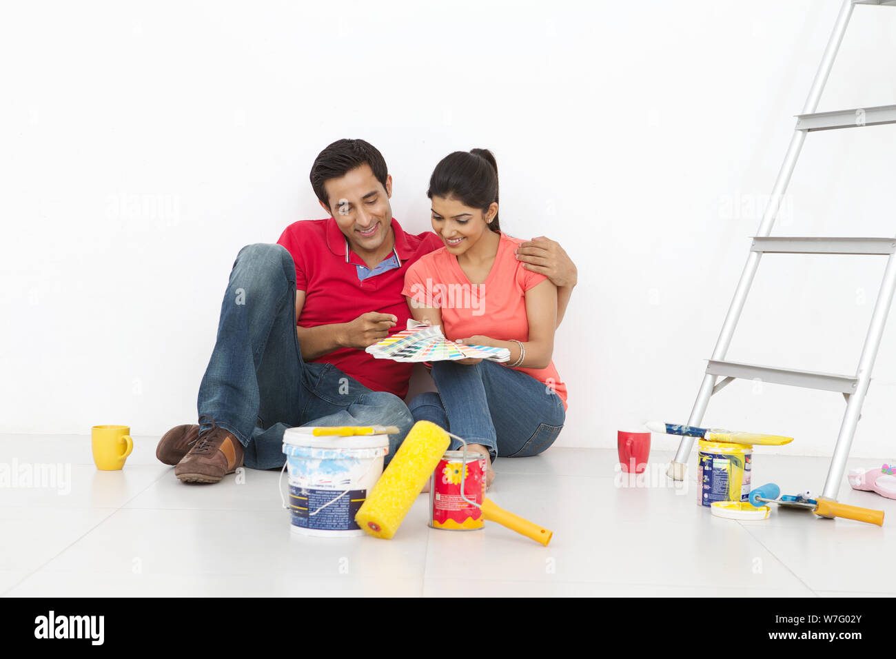 Young couple choosing colours from colour sample Stock Photo - Alamy