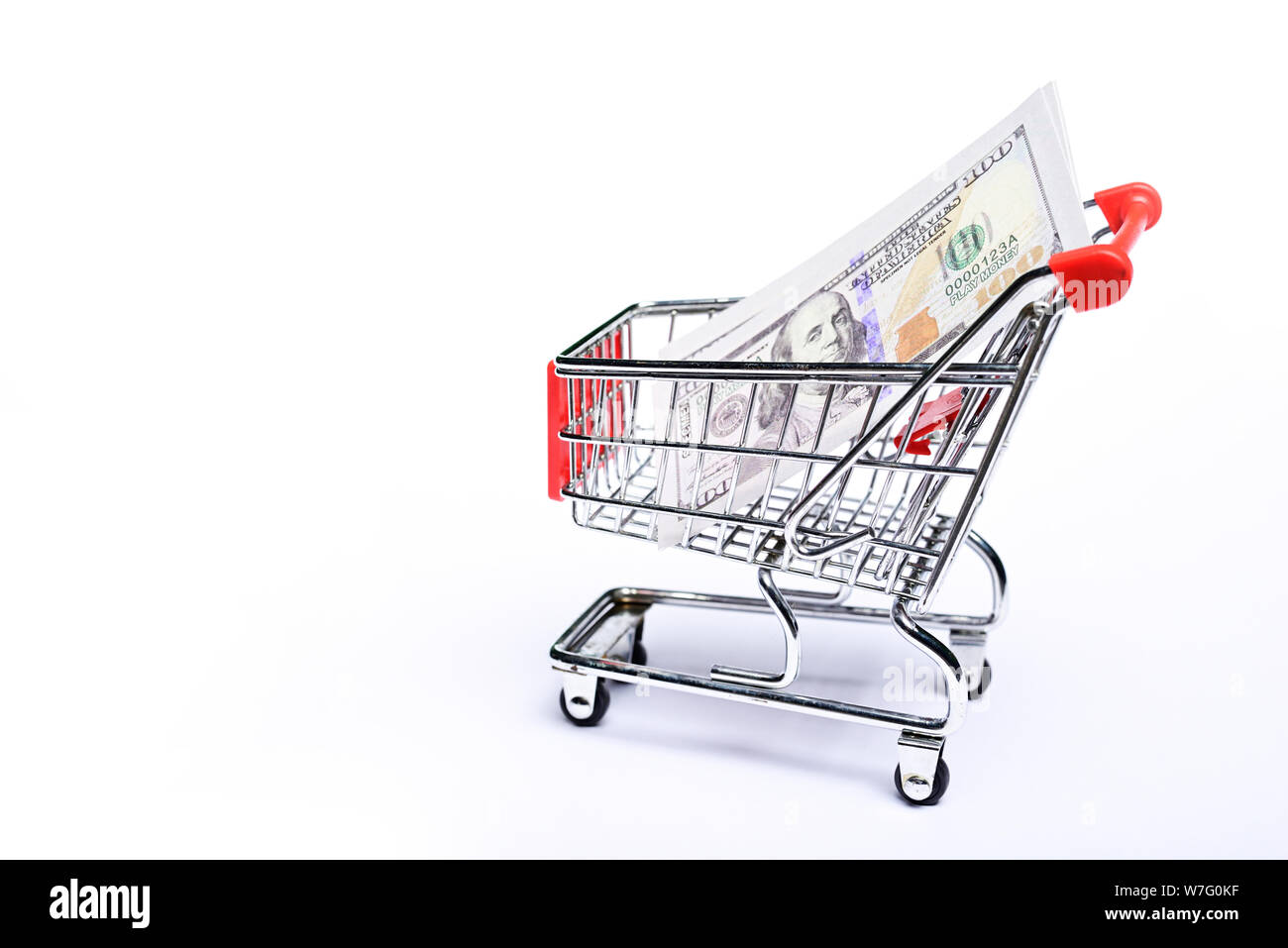 Shopping cart with one hundred US dollar bills isolated on white ...
