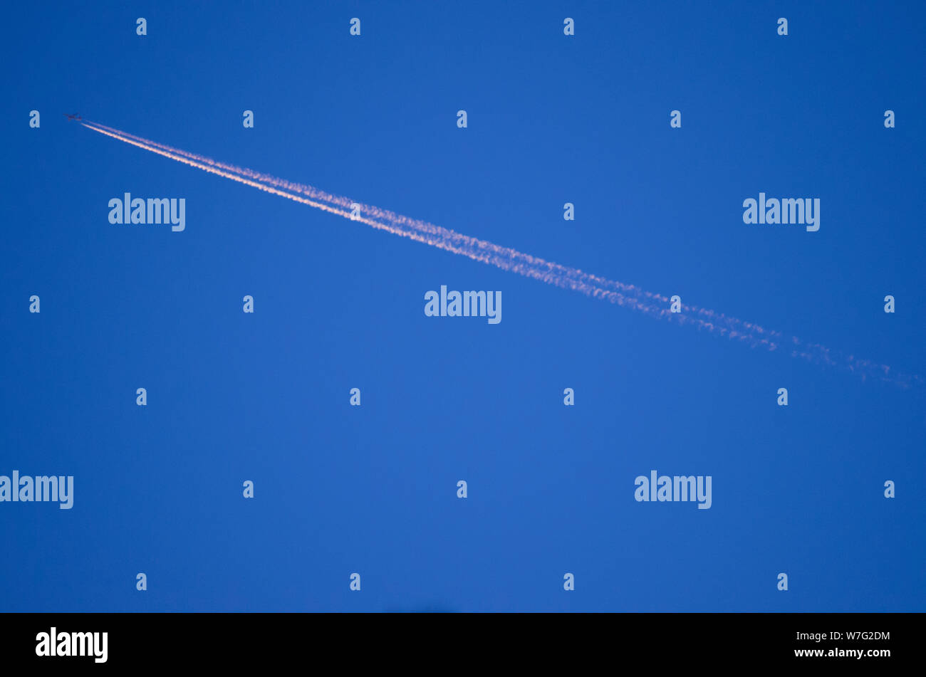 airplane contrail on blue sky Stock Photo - Alamy