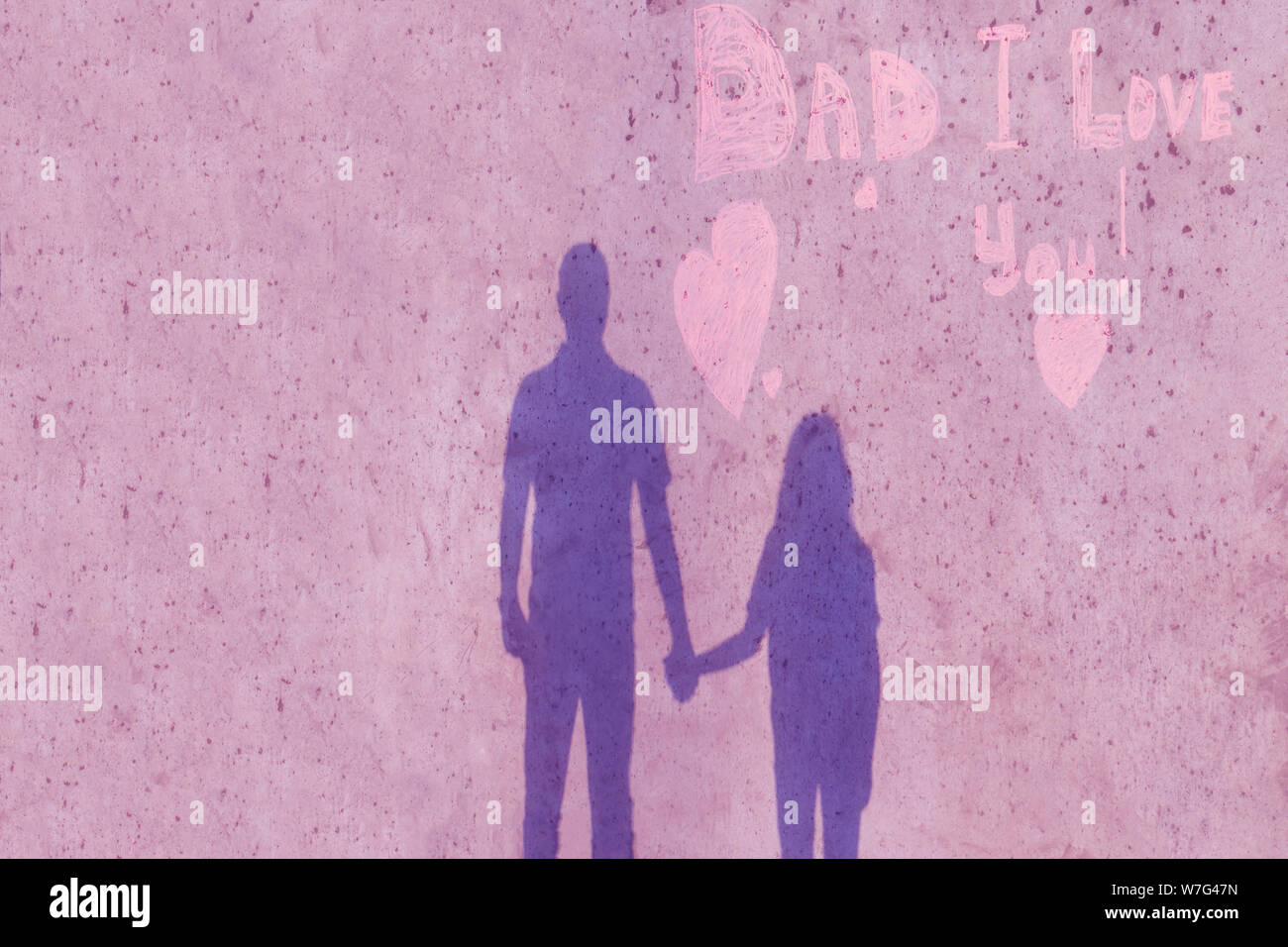 Happy dad holds daughter's hand. Shadow of dad and daughter on the wall ...