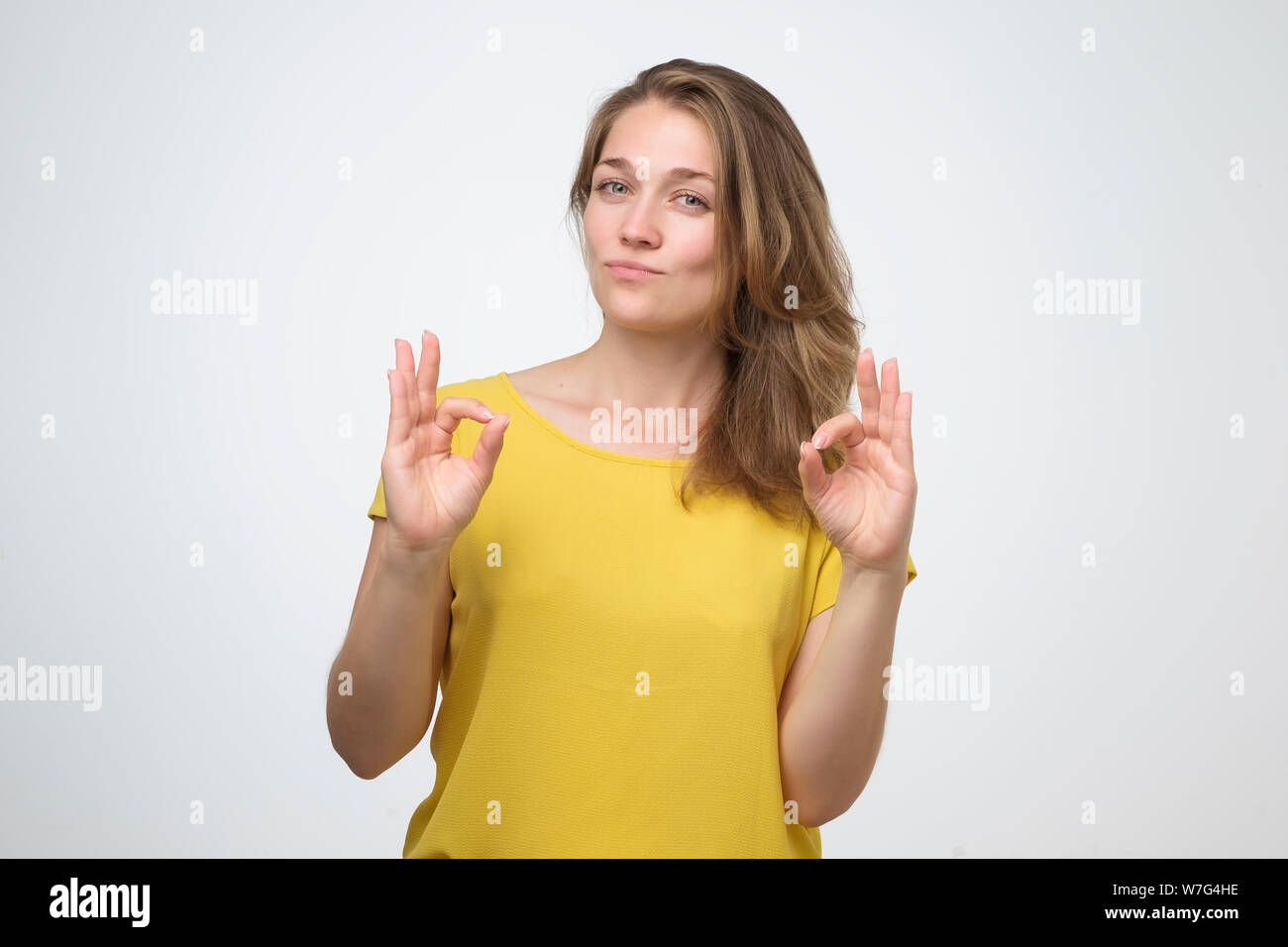Attractive young adult woman showing ok sign. Expression emotion and ...