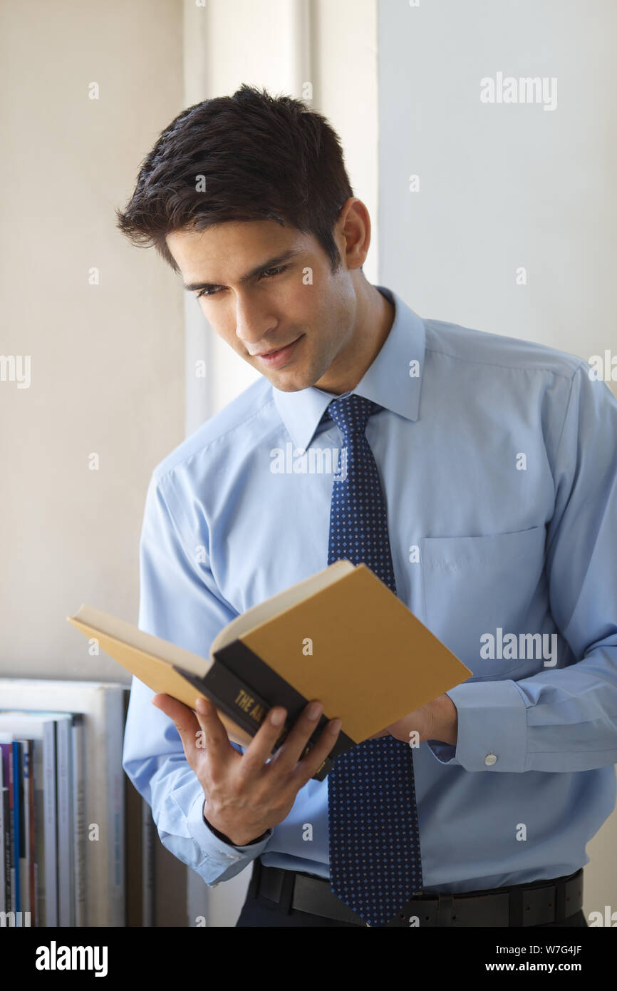Businessman reading a book Stock Photo - Alamy