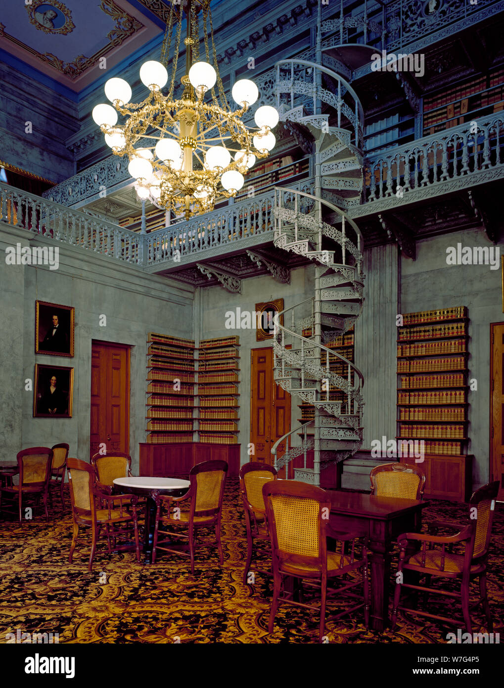 An ornamental cast-iron staircase is a feature in this room, which was ...