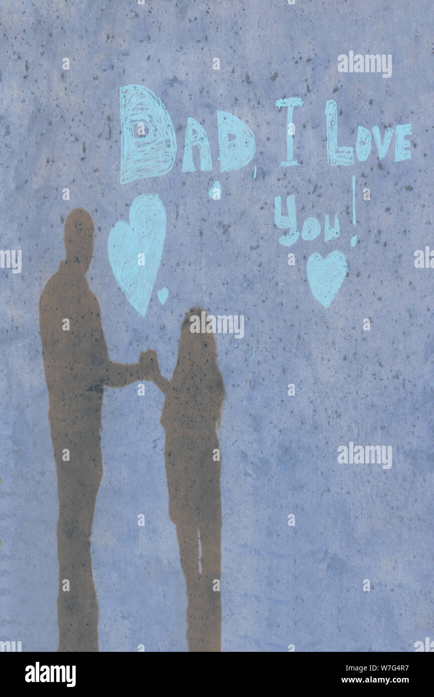 Happy dad holds daughter's hand. Shadow of dad and daughter on the wall ...