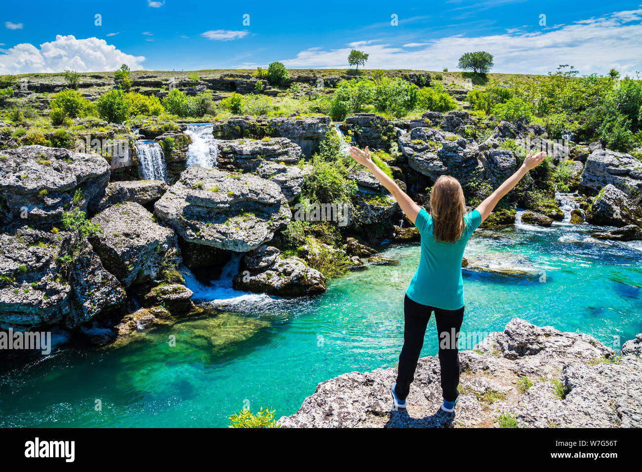 Montenegro, Pretty blonde young woman standing with arms stretched ...