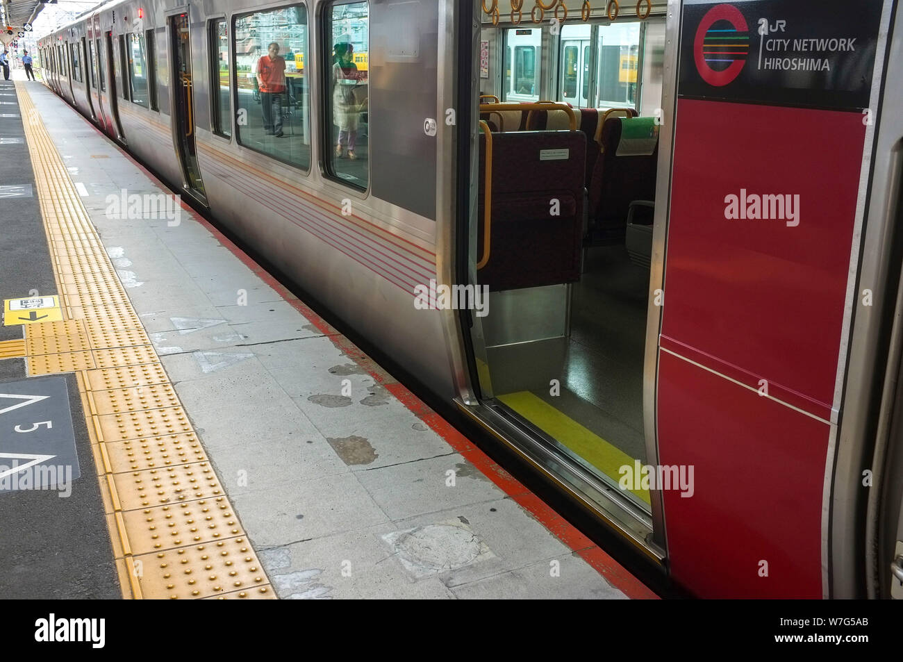Empty JR train from the Hiroshima City Network, waiting on the platform ...