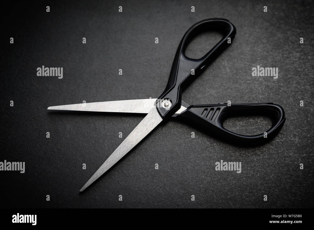 Scissors on a black background Stock Photo - Alamy
