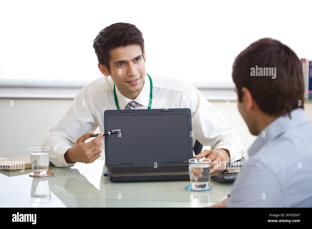 Real estate agent showing house plan on laptop Stock Photo - Alamy