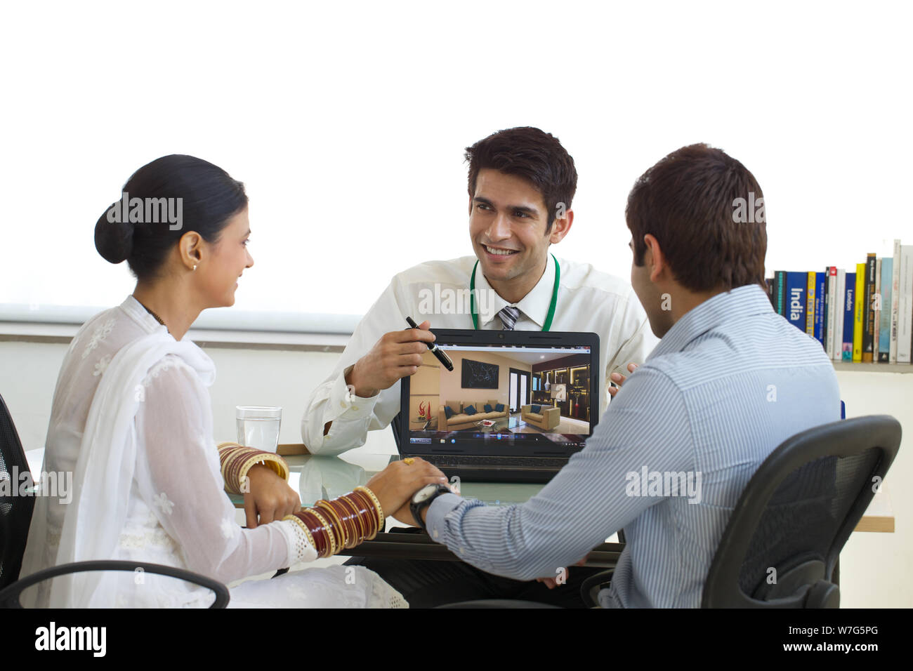 Real estate agent showing house plan on laptop Stock Photo - Alamy