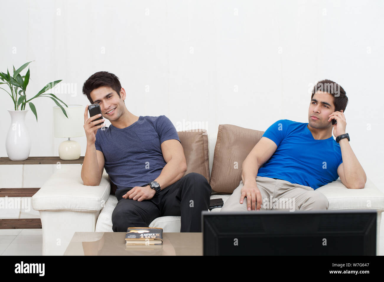 Two friends talking listening indoors hi-res stock photography and ...