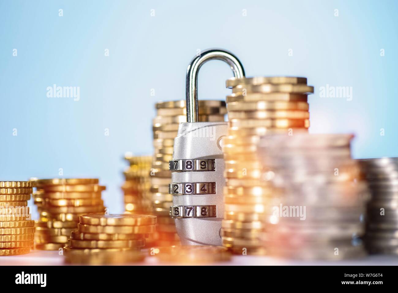 Silver combination lock with several stacks of coins | usage worldwide ...
