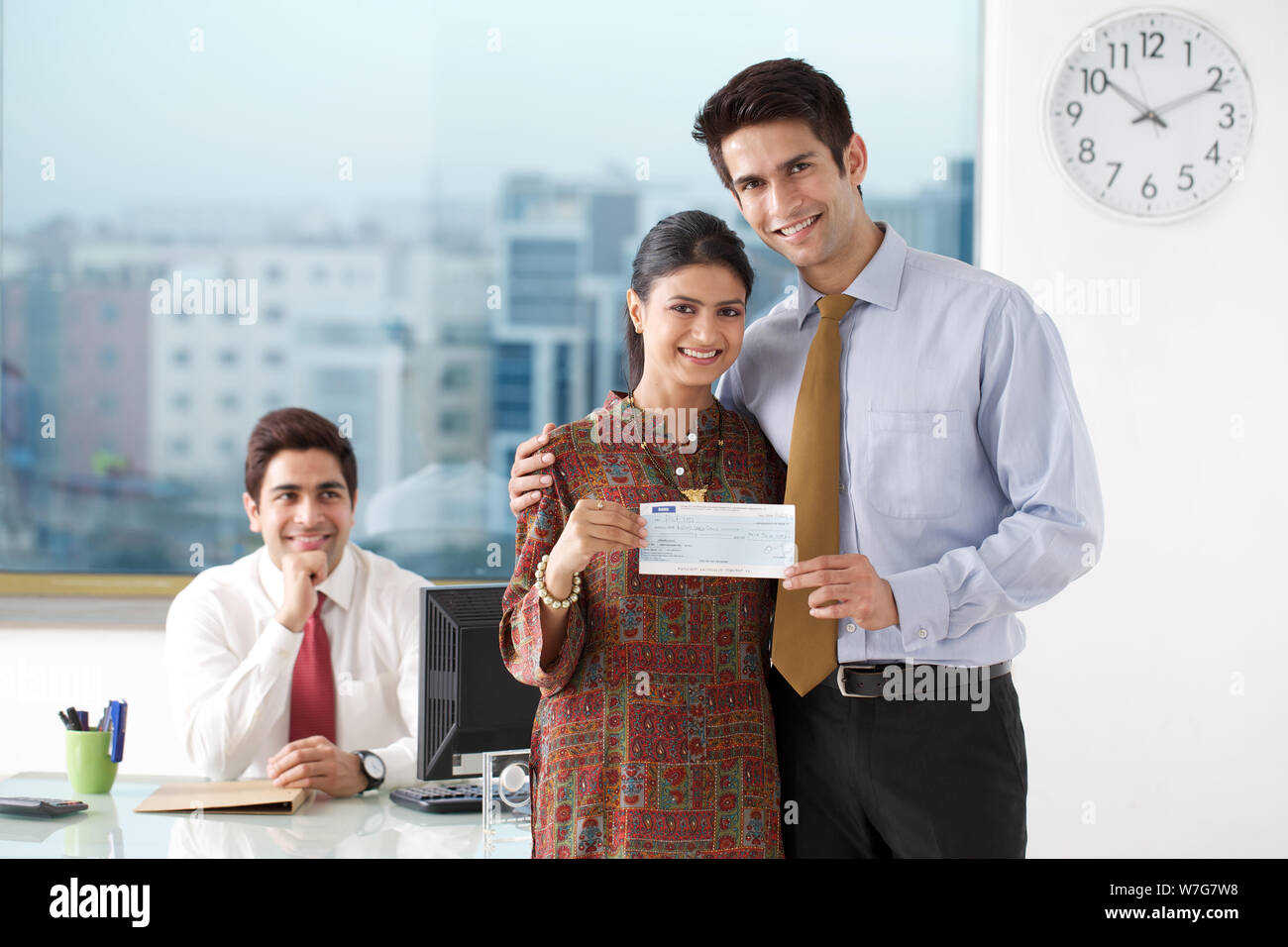Young couple showing bank cheque Stock Photo - Alamy