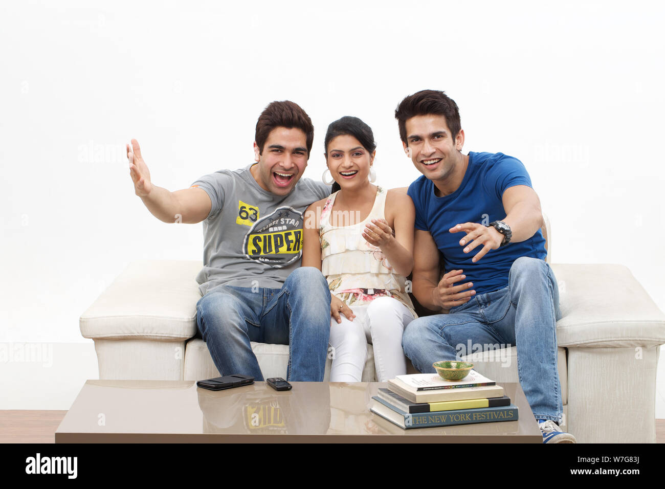 Group of friend watching tv and cheering Stock Photo - Alamy