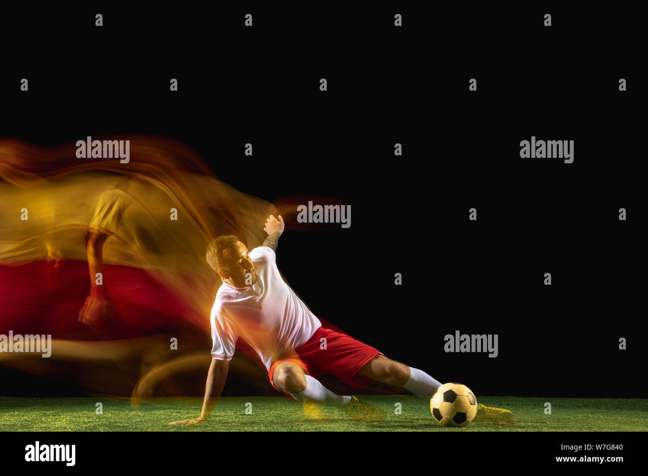 Flexible. Young caucasian male football or soccer player in sportwear ...