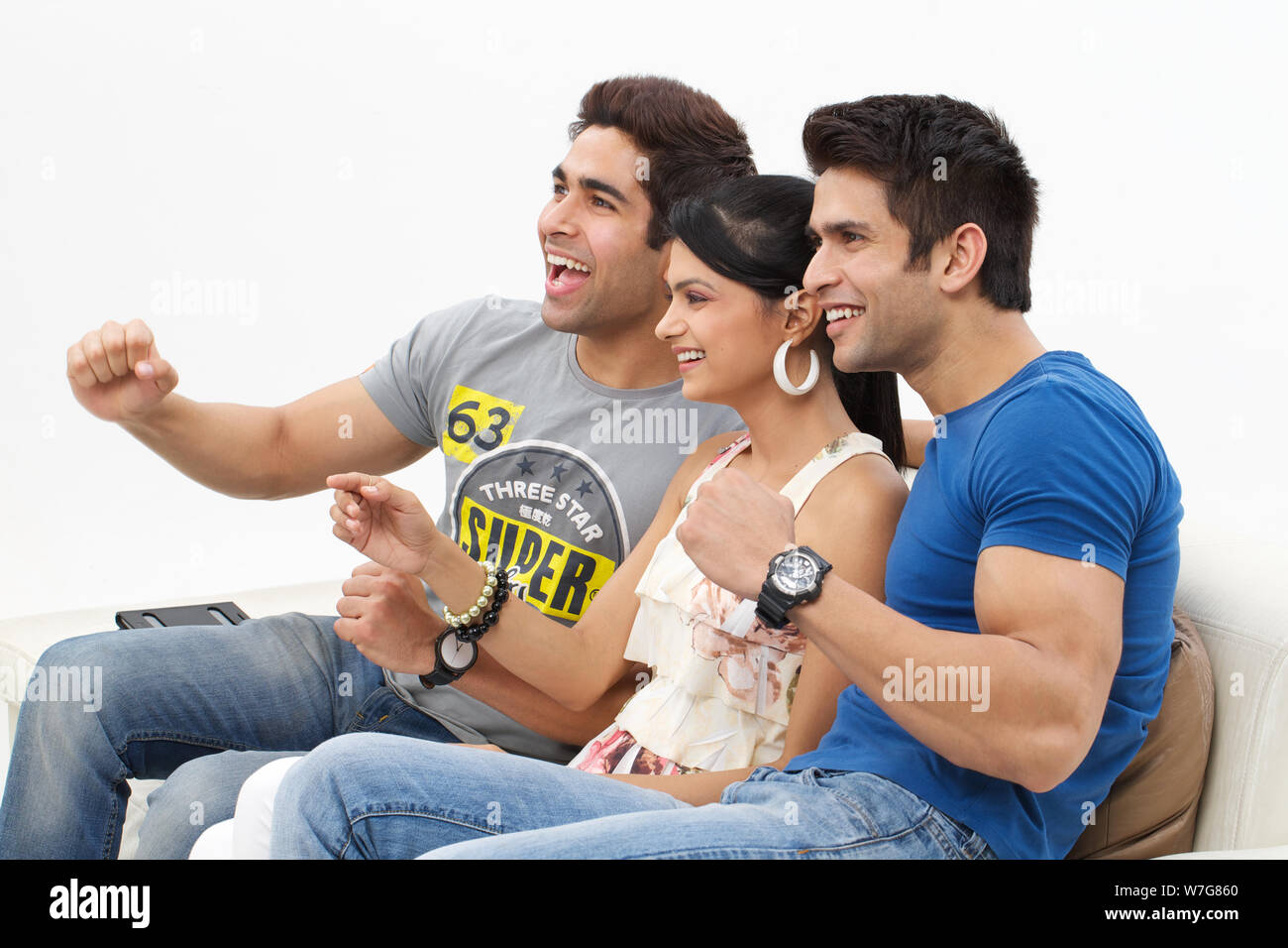 Group of friend watching tv and cheering Stock Photo - Alamy